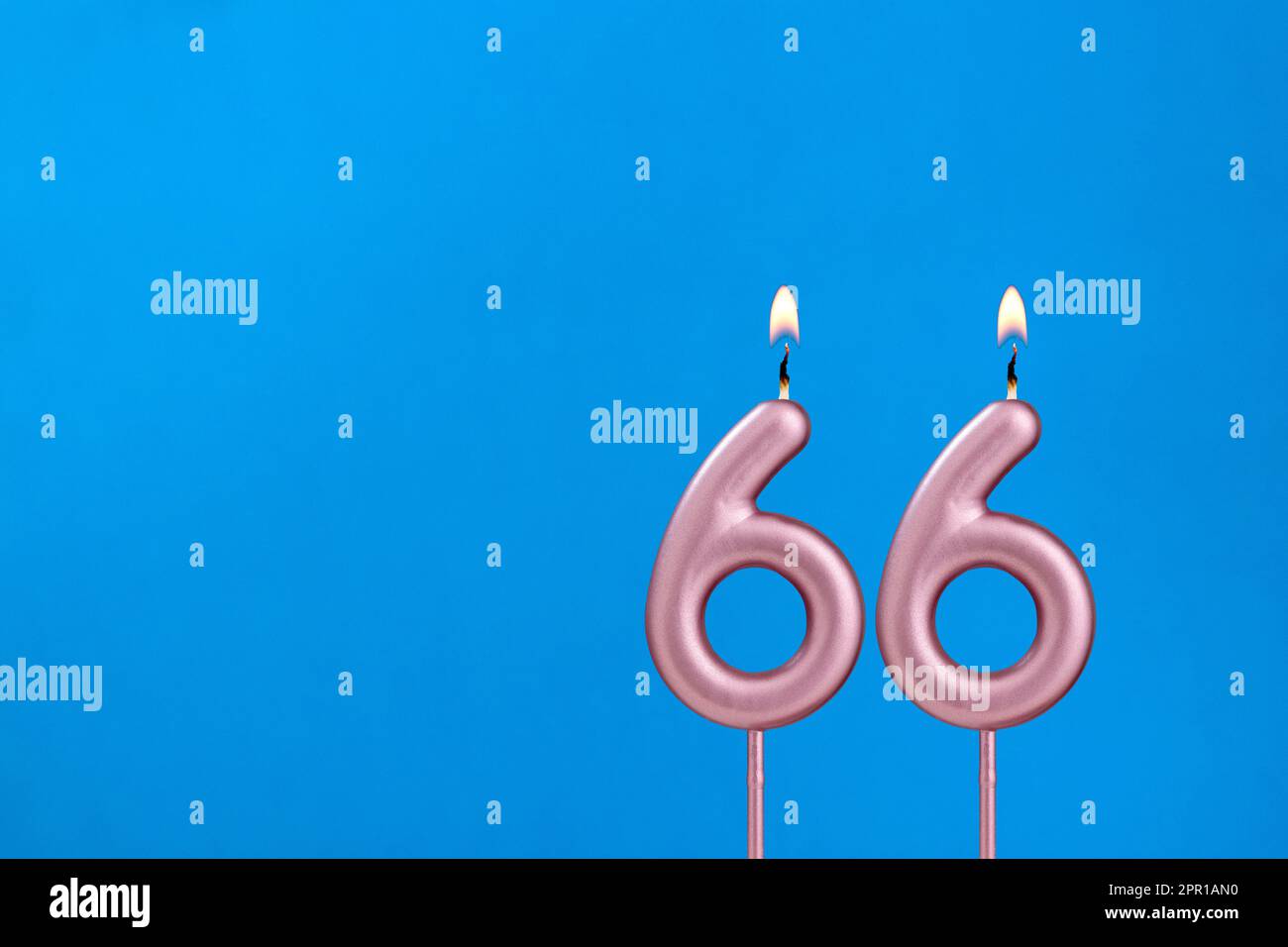 Candle number 66 - Birthday in blues foamy background Stock Photo - Alamy