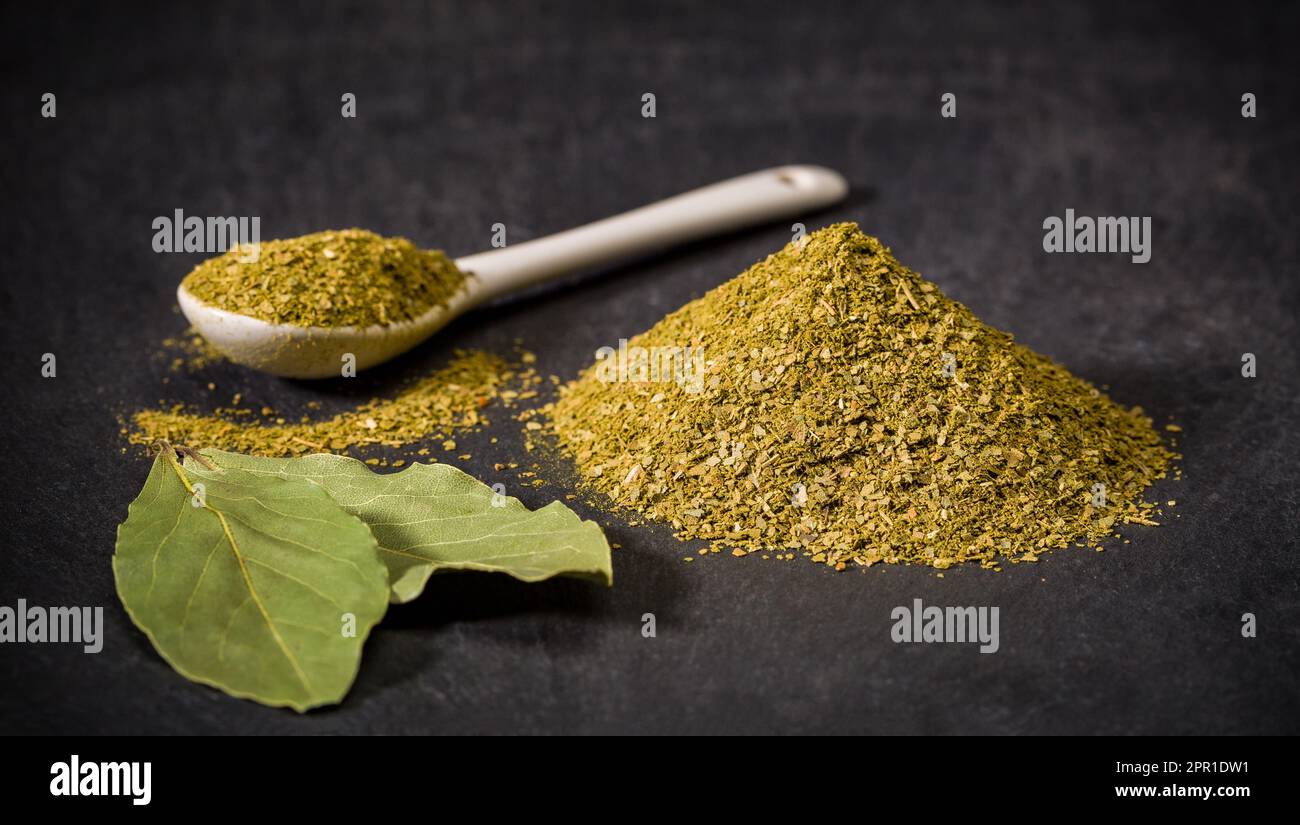 Aromatic spices bay leaf. Spoon and pile of ground dried, fresh laurel ...