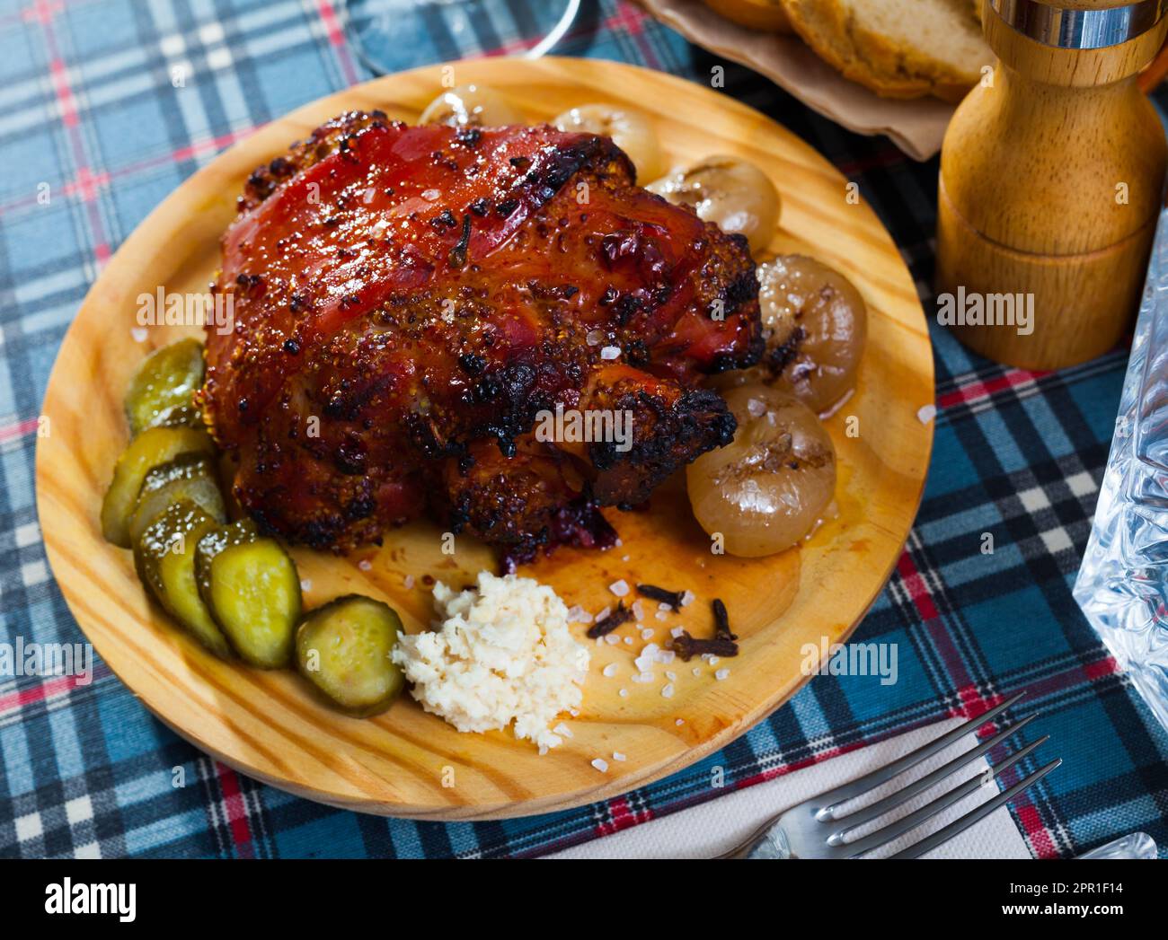 Oven baked pork knuckle with boiled onions and pickled cucumbers Stock ...