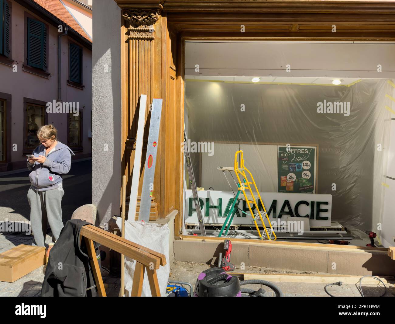 Worker outside pharmacy rapir facade hi-res stock photography and ...