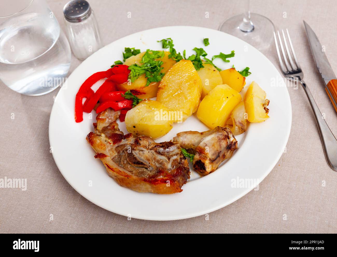 Side dish of baked lamb leg with potatoes and pepper Stock Photo - Alamy