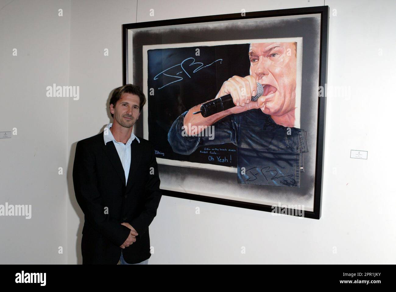 Garry Fleming poses with his painting of Australian rocker Jimmy Barnes ...
