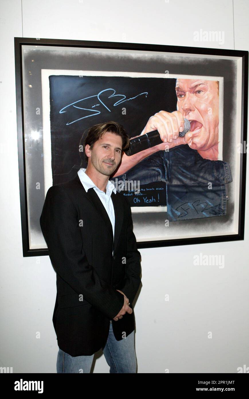 Garry Fleming poses with his painting of Australian rocker Jimmy Barnes ...