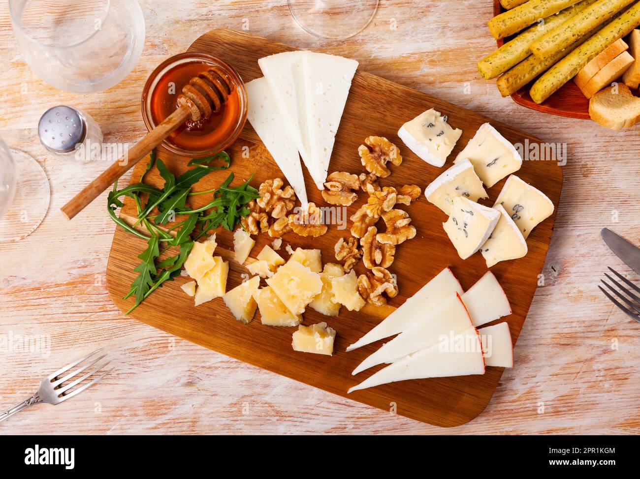 Different types of cheese sliced and served on board Stock Photo - Alamy