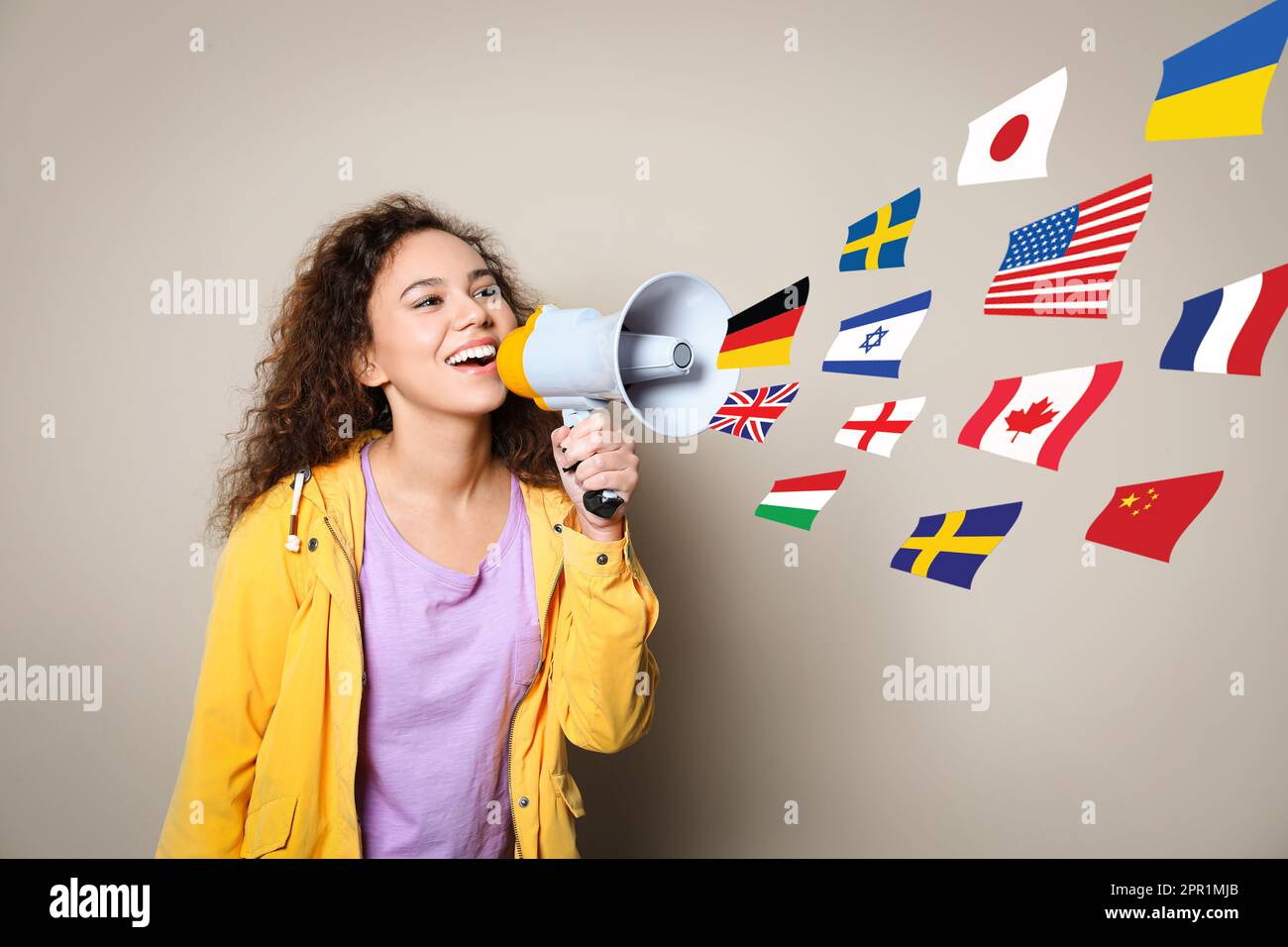 Portrait of African American interpreter with megaphone and flags of ...