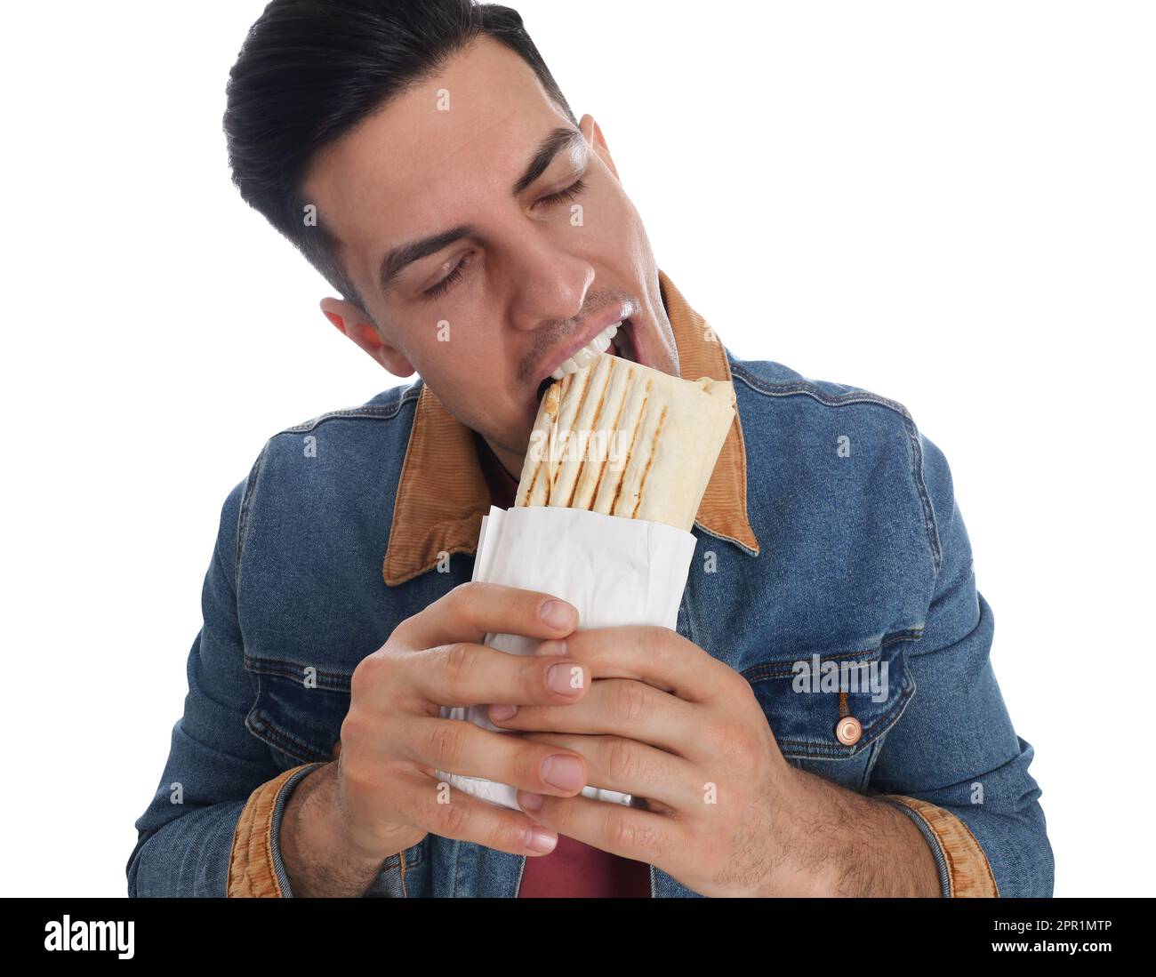 Man eating delicious shawarma on white background Stock Photo - Alamy