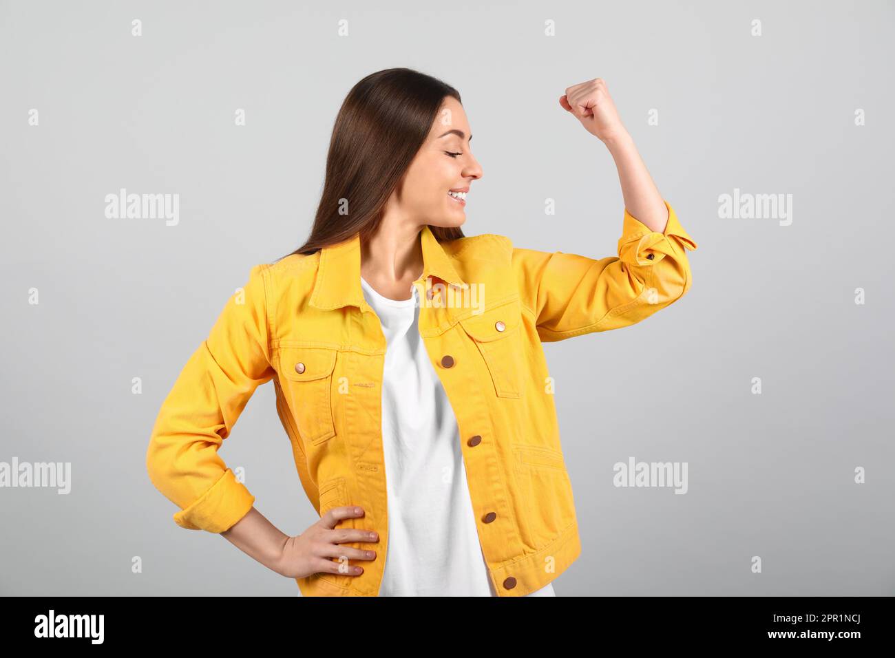 Strong woman as symbol of girl power on light grey background. 8 March ...