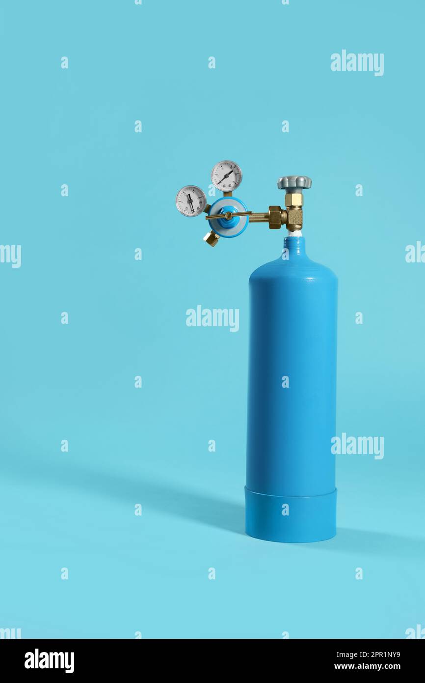 Oxygen tank on light blue background. Medical equipment Stock Photo - Alamy