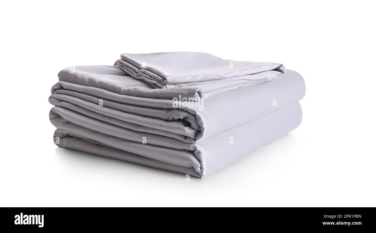 Stack of clean silky bed linen isolated on white Stock Photo - Alamy