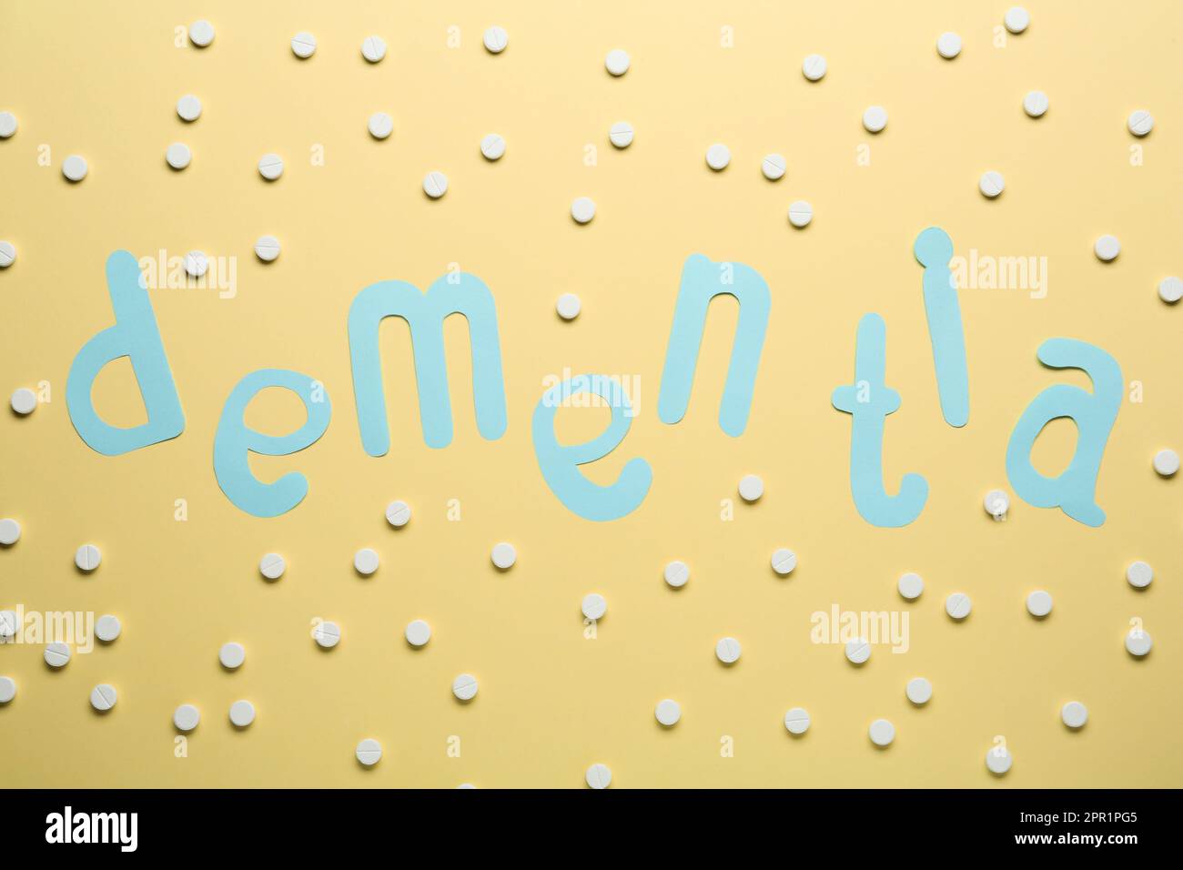 Word Dementia made of paper letters and pills on beige background, flat ...