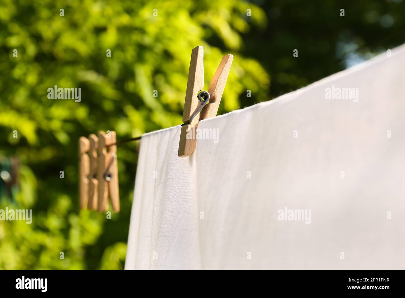 Washing line with clean laundry and clothespins outdoors, closeup Stock ...