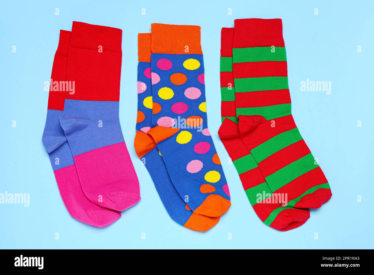 Different colorful socks on light blue background, flat lay Stock Photo ...