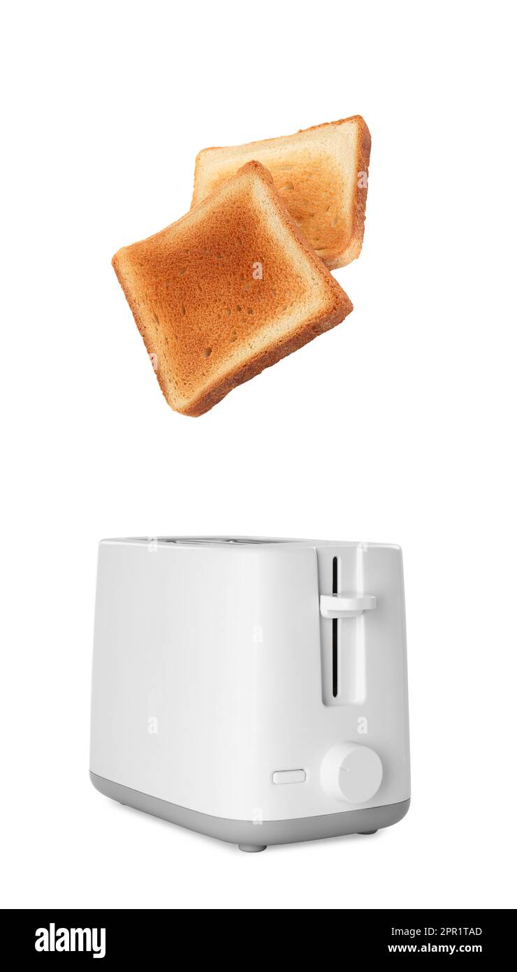 Roasted bread popping up of toaster on white background Stock Photo - Alamy