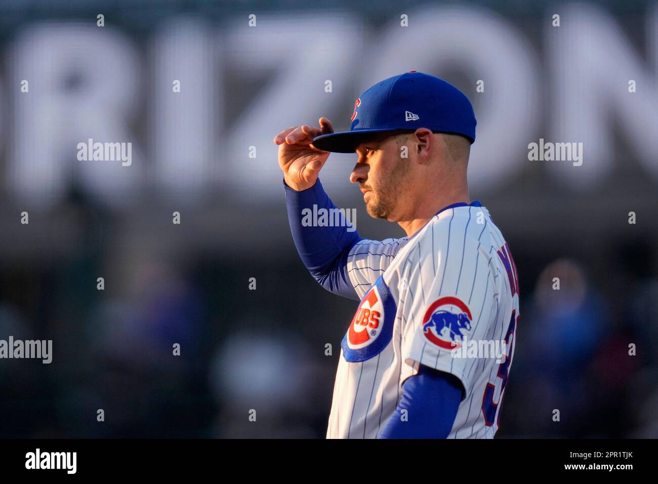 Chicago Cubs first baseman Trey Mancini adjusts his cap during the ...