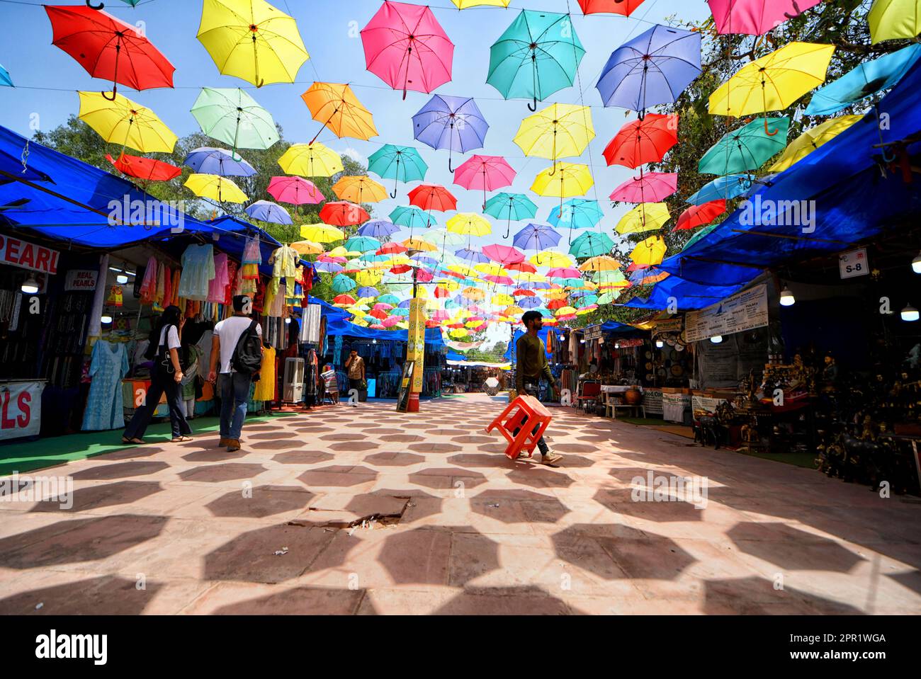 Delhi, India. 21st Apr, 2023. People walk under the Colorful Umbrella ...