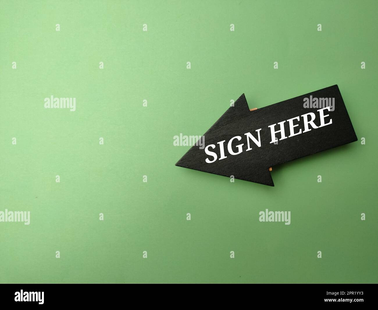Arrow sign board with the word SIGN HERE on green background Stock ...