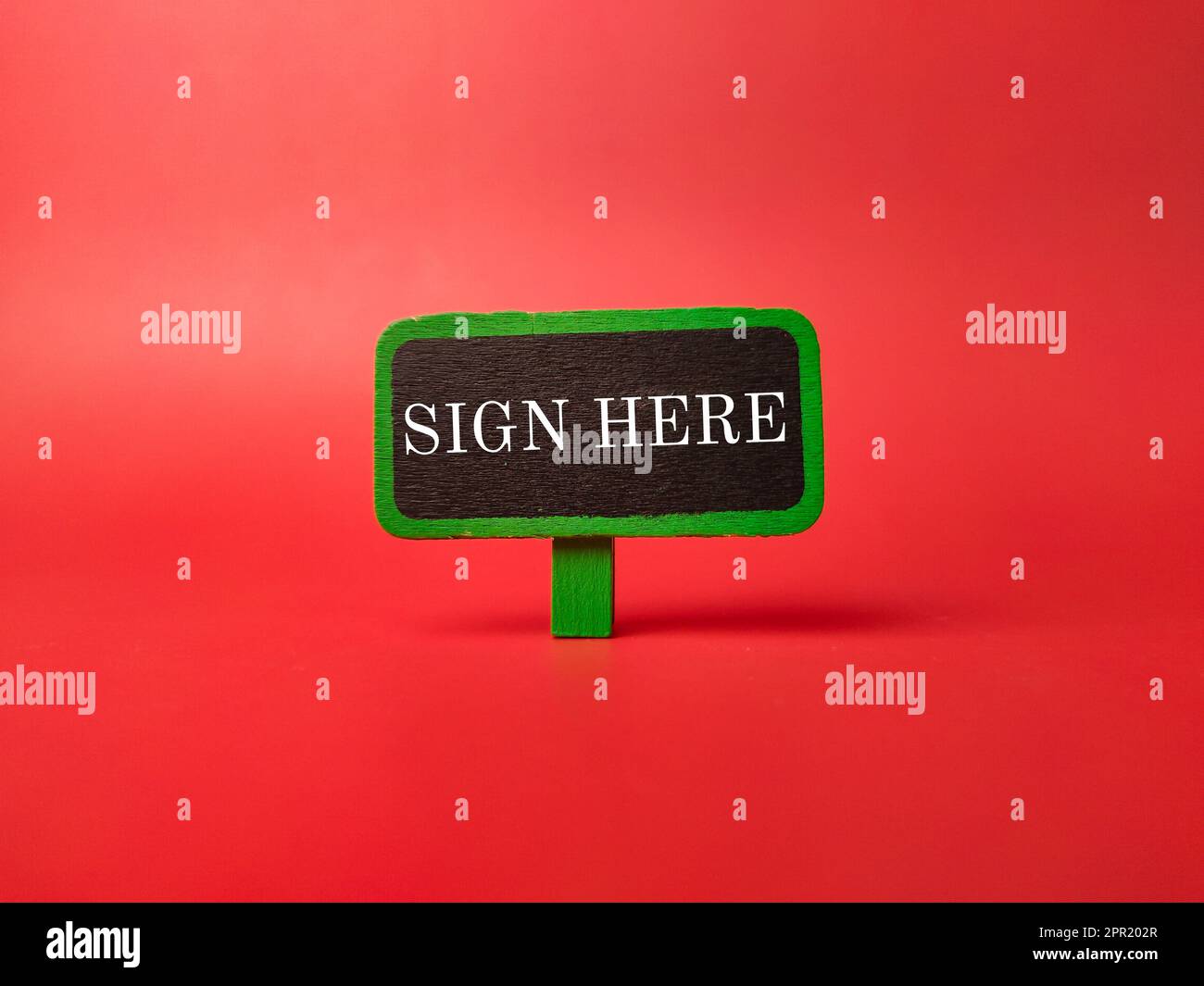 Colored sign board with the word SIGN HERE on red background Stock ...
