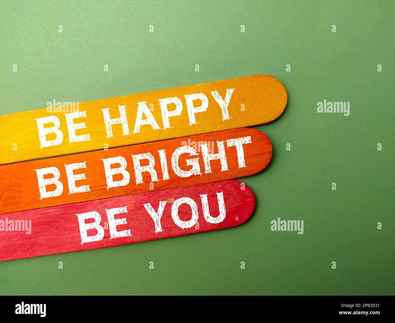 Colored wooden with the word BE HAPPY BE BRIGHT BE YOU on green ...