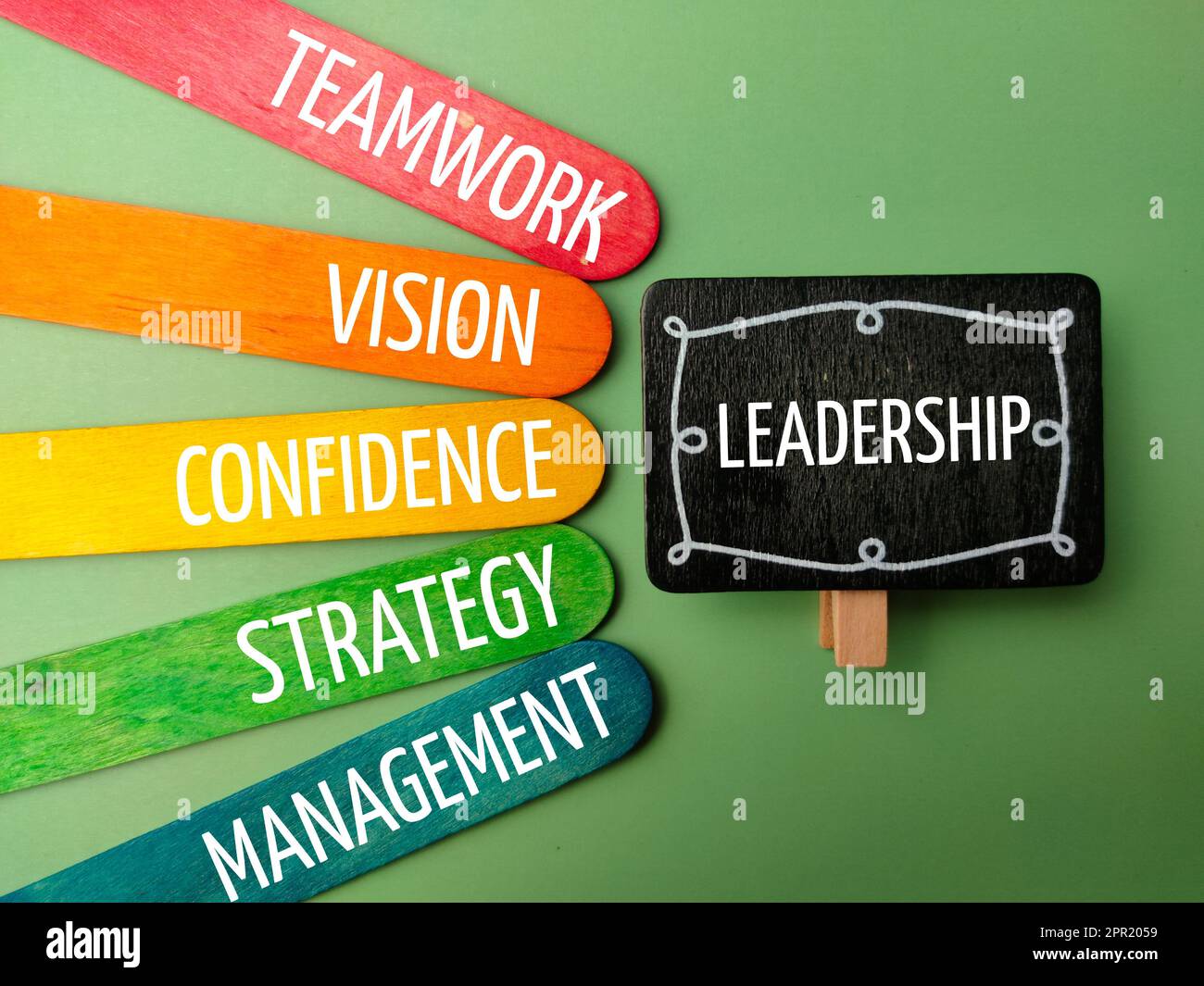 Colored wooden with the word Leadership concept on green background ...