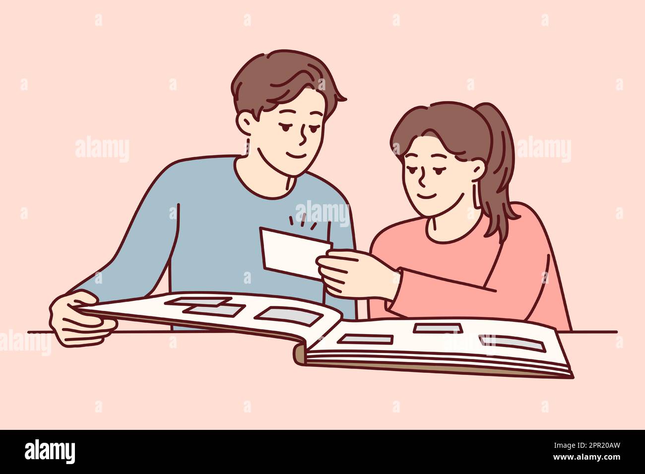 Happy couple man and woman looking at family photo album with pictures ...
