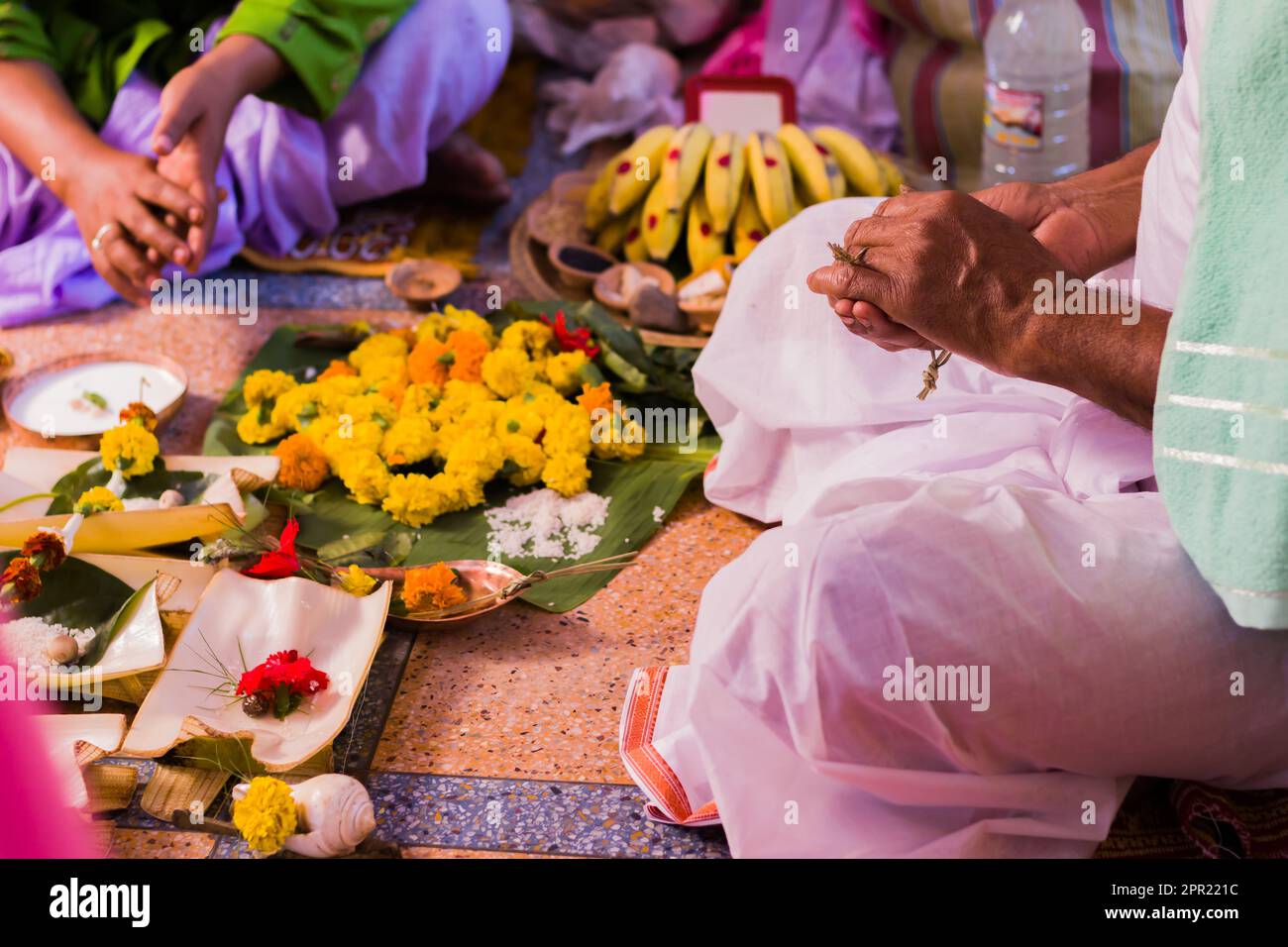 Hindu puja rituals being performed with flowers in front of priest ...