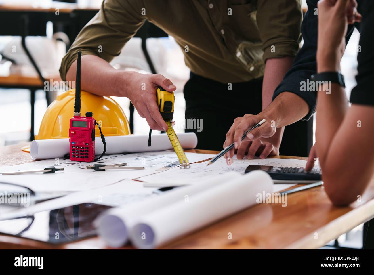 Architect and Engineer working with blueprints for architectural plan ...