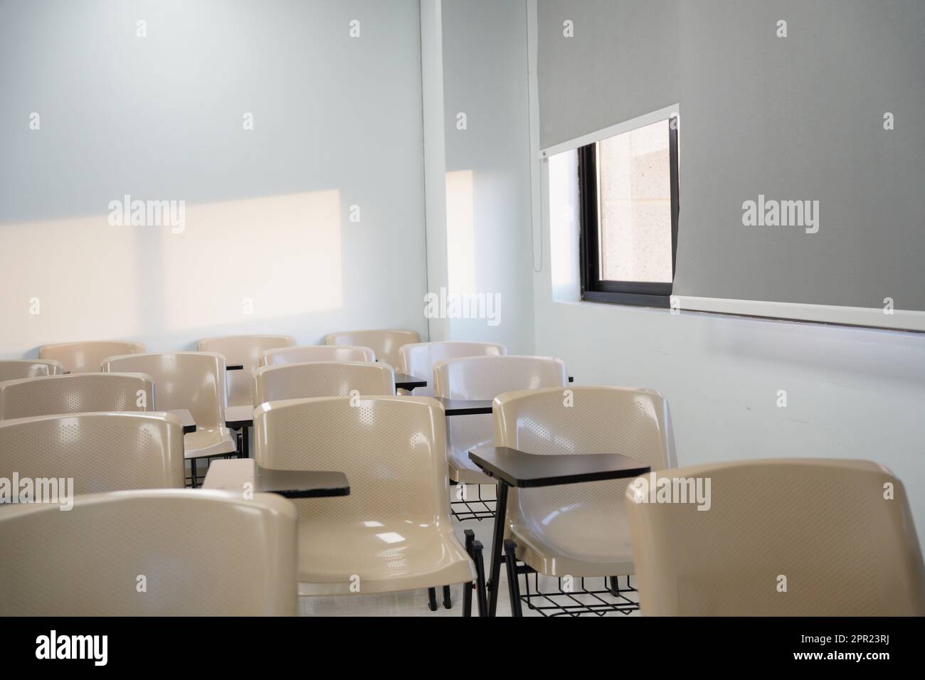 Empty classes at university or school with chairs and side tables, the chairs are arranged in ...