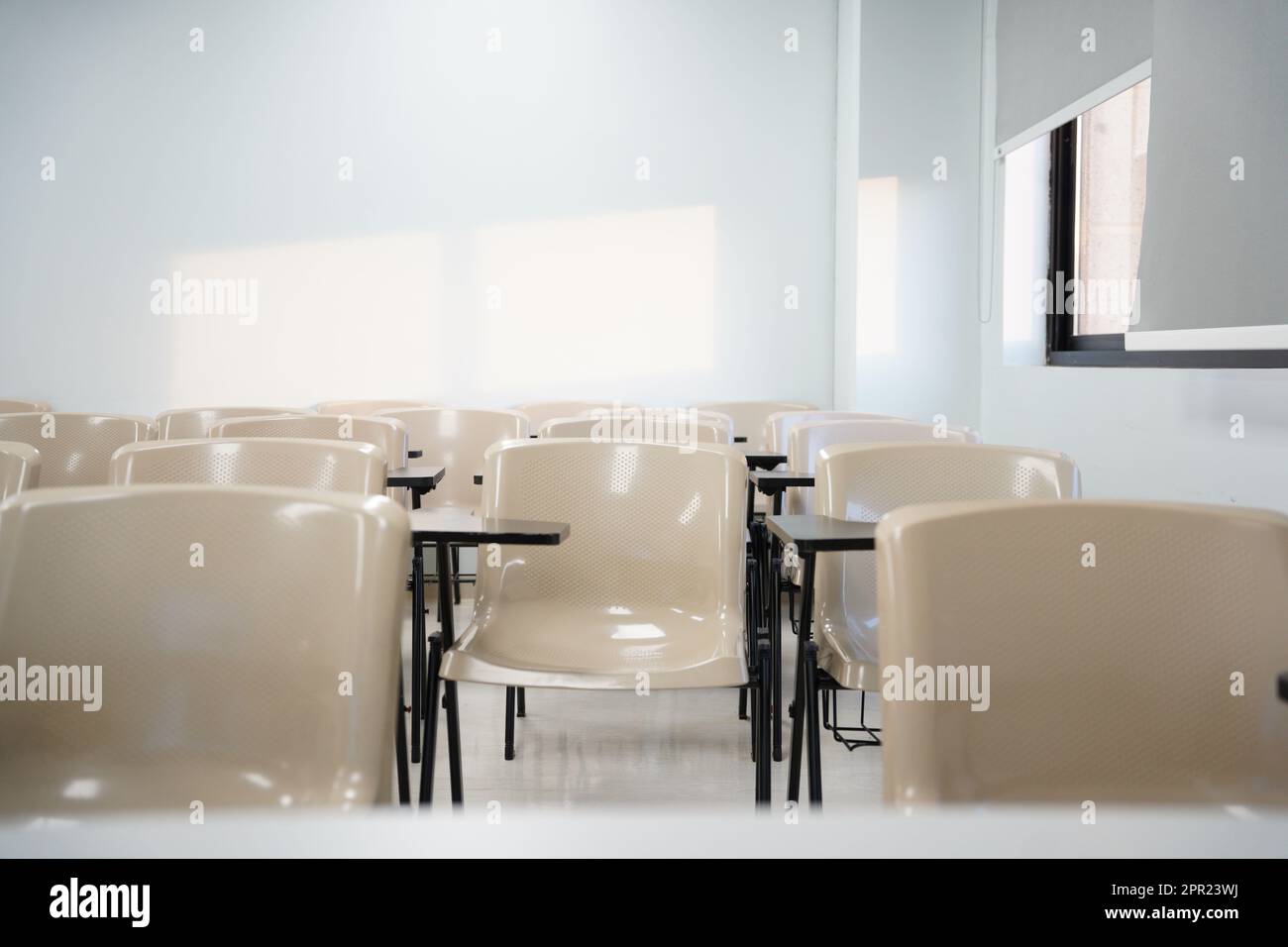 Empty classes at university or school with chairs and side tables, the ...