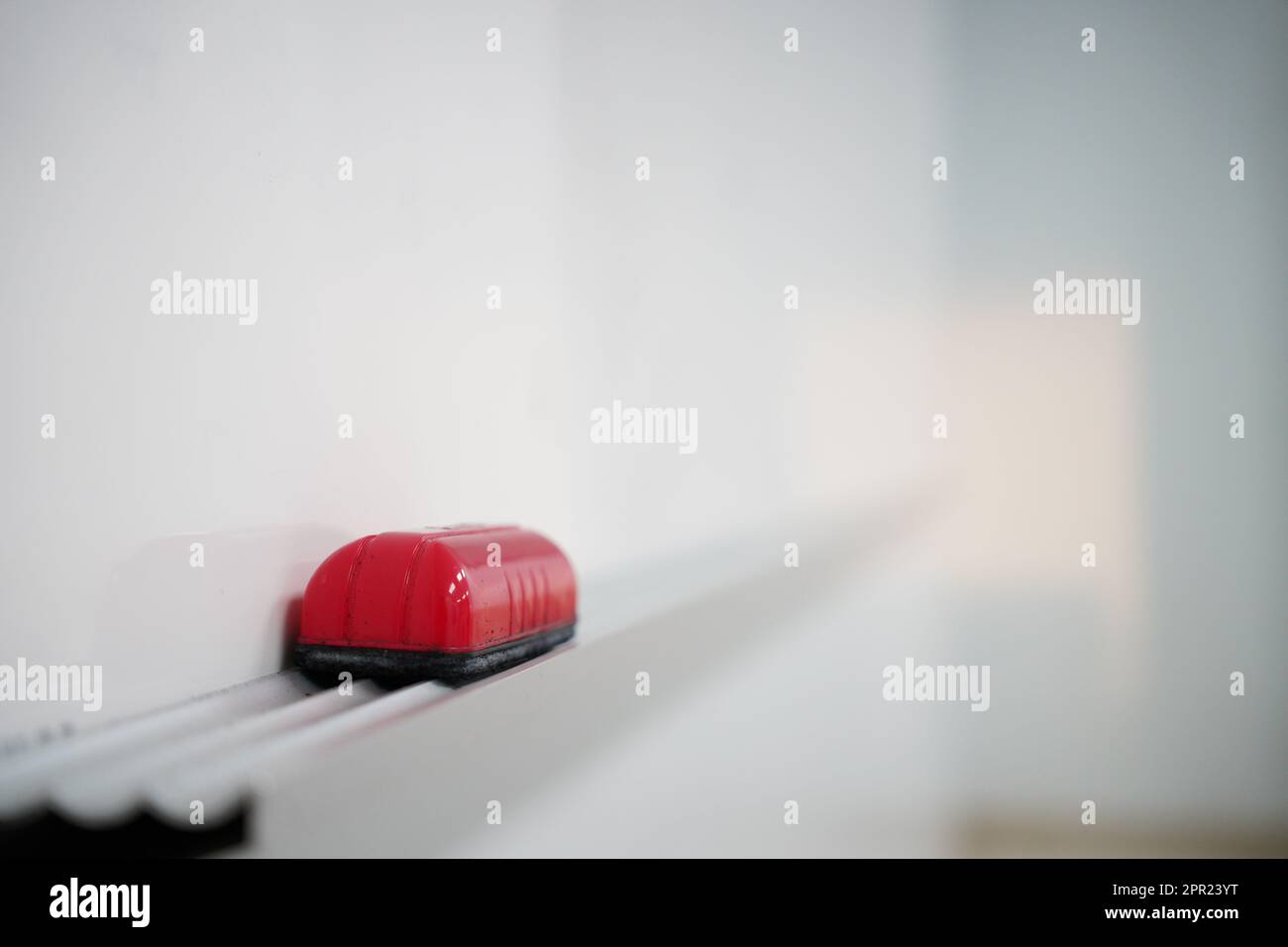 Red eraser for whiteboard on a white background and space for texting ...