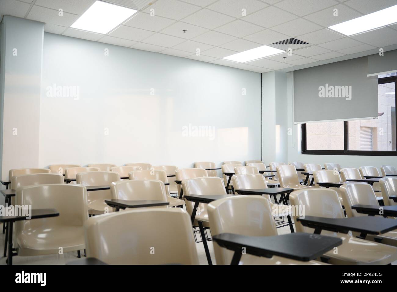 Empty classes at university or school with chairs and side tables, the ...