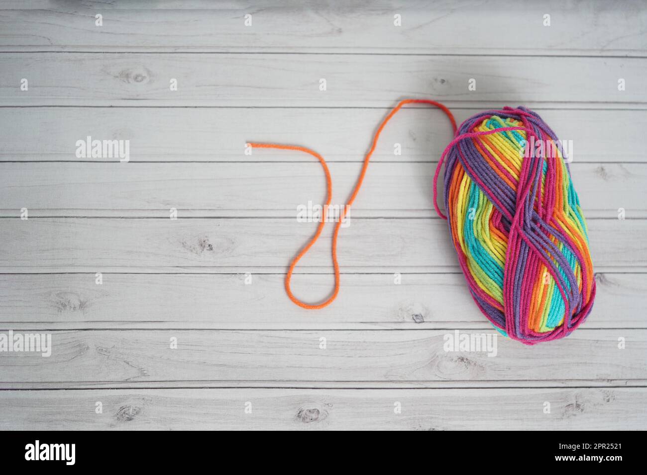 Art and crafts background. Colourful wool for crafting on a white ...