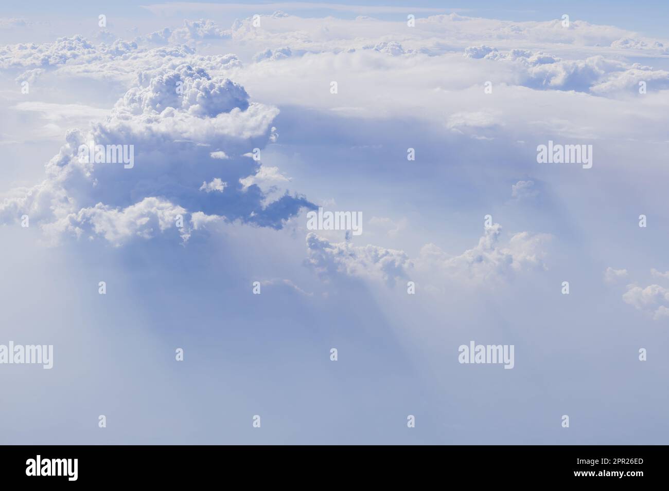 Cumulus and cumulonimbus rain clouds seen from aeroplane. Shot taken in ...