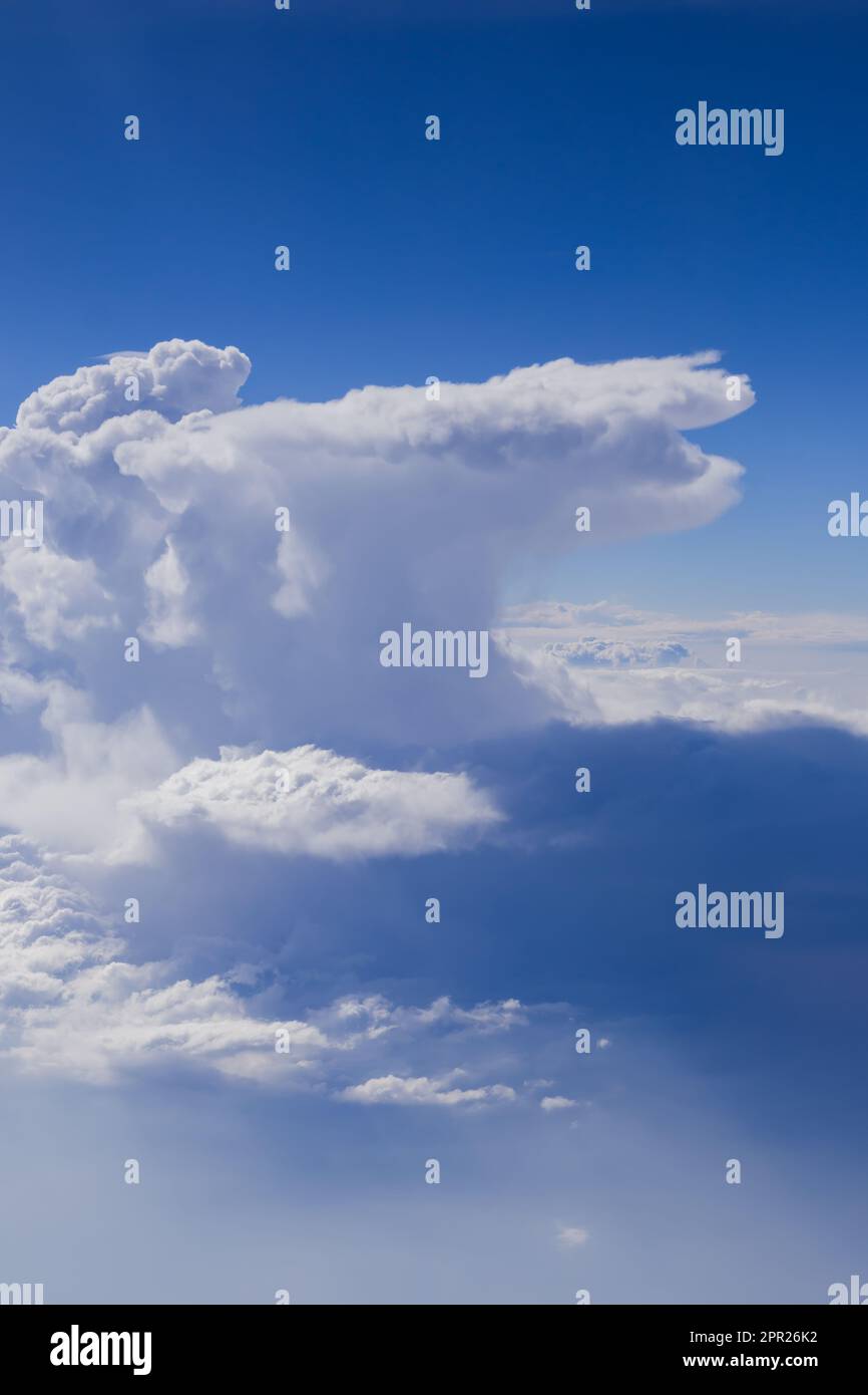 Cumulus and cumulonimbus rain clouds seen from aeroplane. Shot taken in ...