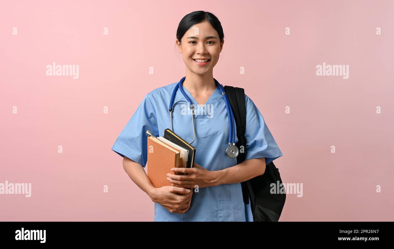 Portrait of young female medical student smiling to the camera while ...