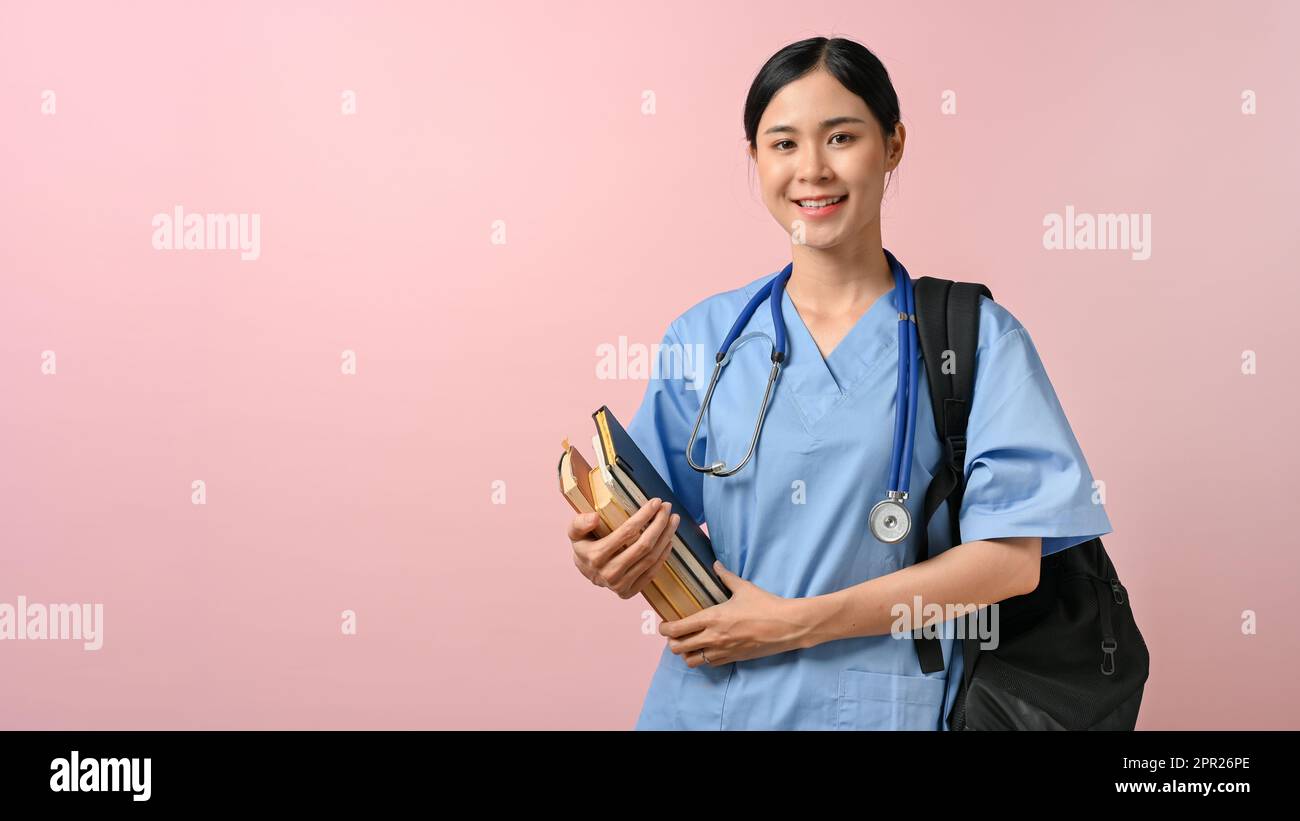 Portrait of young female medical student smiling to the camera while ...
