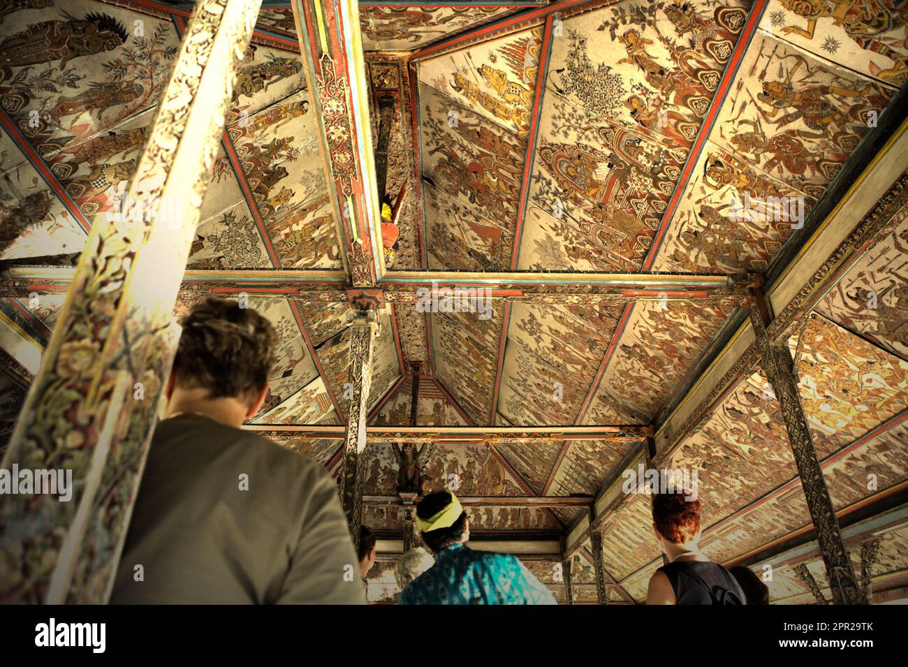 A guide is giving explanation to a group of tourists over the old ...