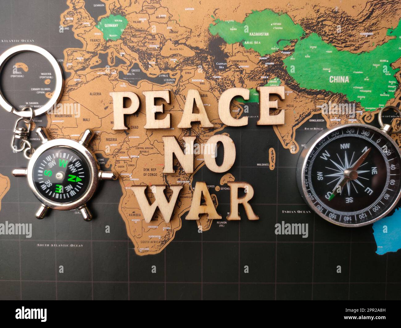Top view compass with the word PEACE NO WAR on a world map background ...