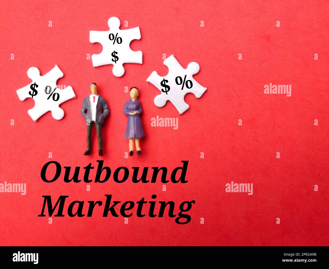 Miniature people and white puzzle with the word Outbound Marketing ...