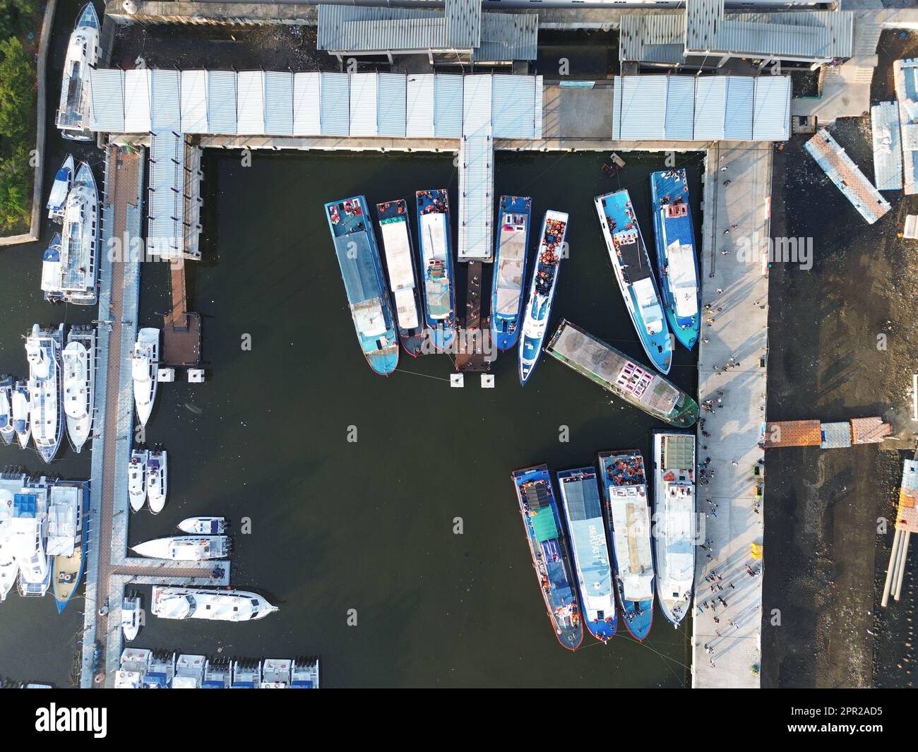 Aerial drone view of Muara Angke Beach with wooden boats leaning beside ...