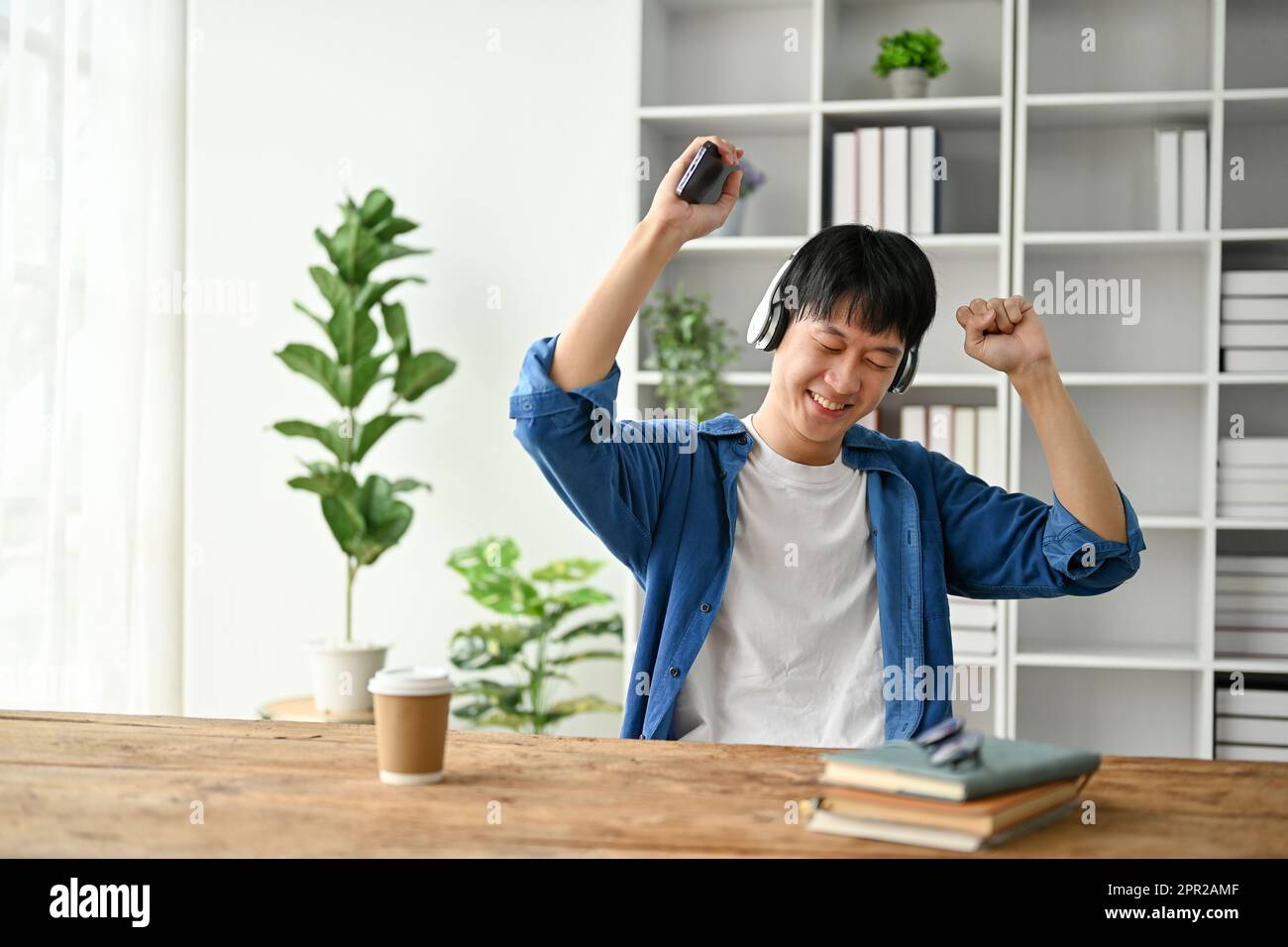 Happy young college student enjoy himself, listening to music while ...