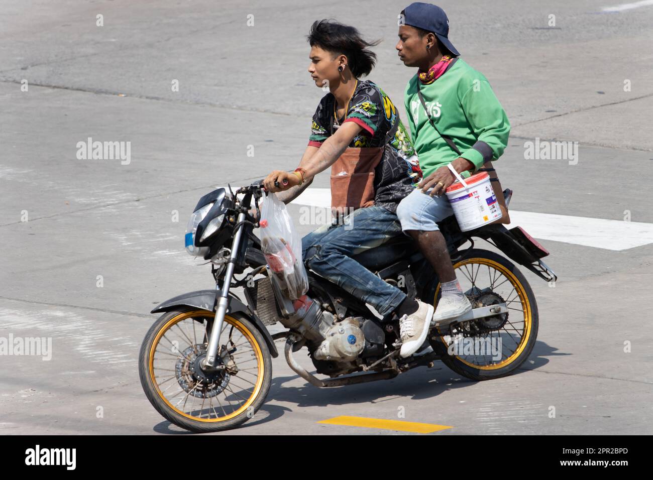 SAMUT PRAKAN, THAILAND, FEB 07 2023, Two construction workers ride a ...