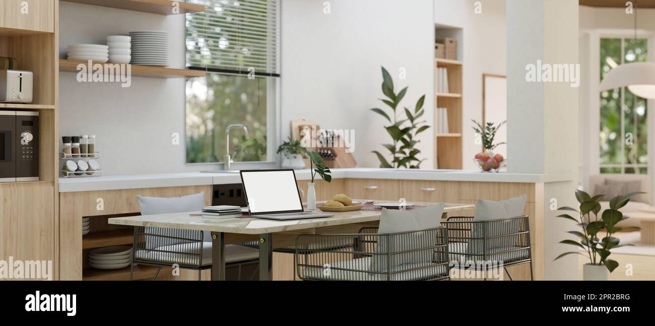 Modern workspace corner in the kitchen with blank screen laptop on ...