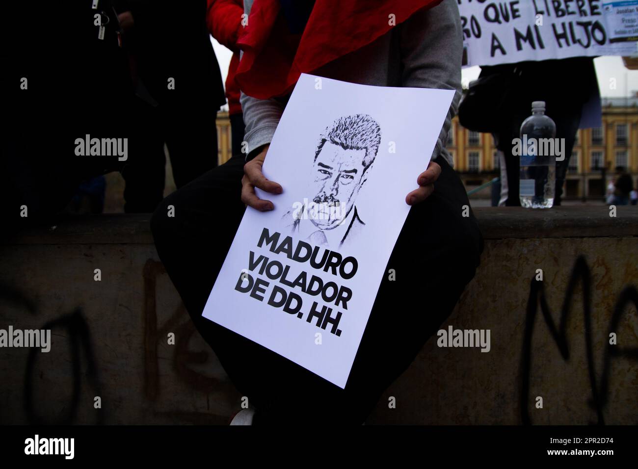 Venezuelan migrants living in Colombia hold a sign against Venezuelan ...