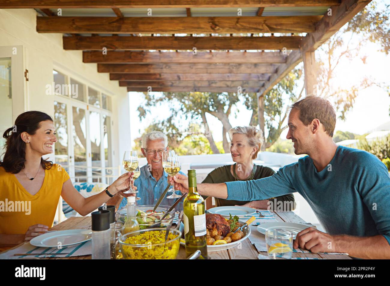 Heres to family, the gift that keeps on giving. a happy family toasting ...