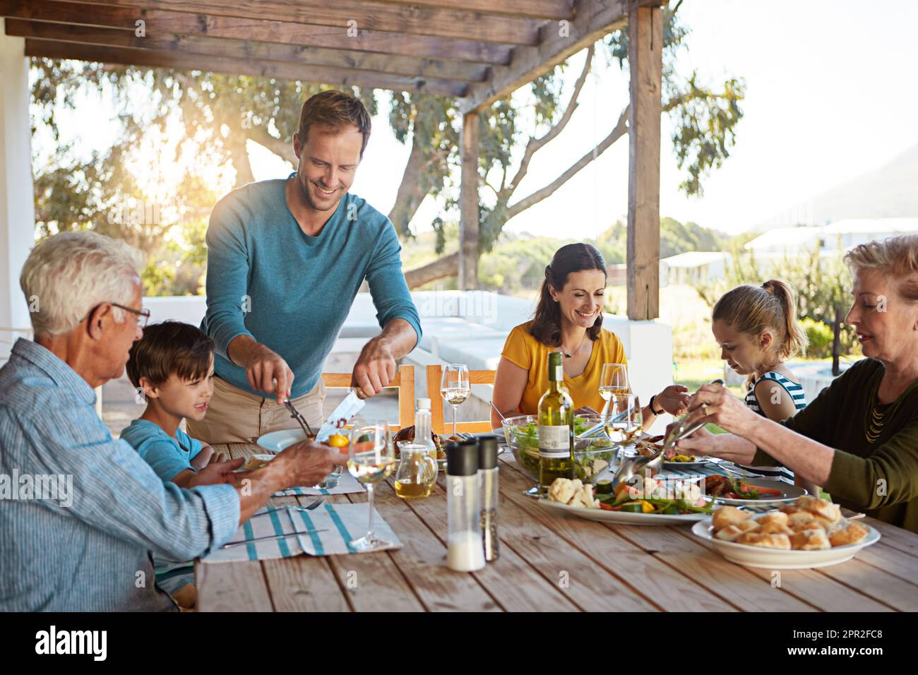 Food is a family affair. a family enjoying a meal together at home ...