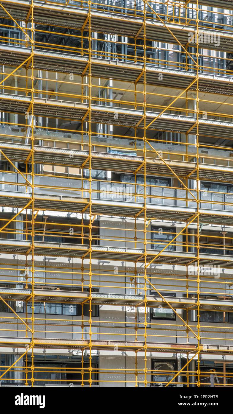 Scaffolding around a multi-storey building under construction Stock ...