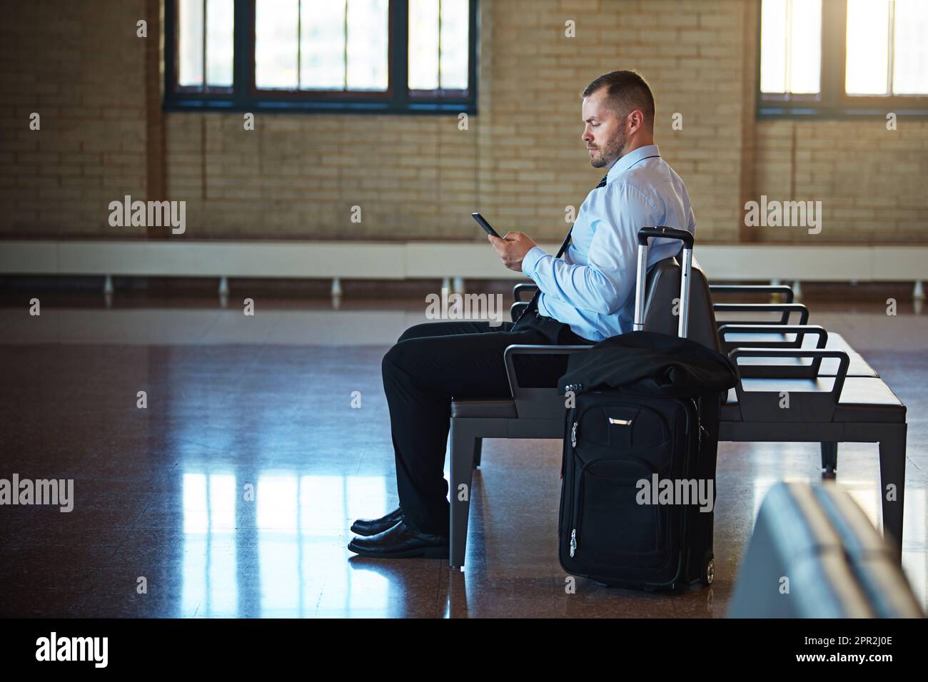 Im running a little behind schedule. a confident businessman using his ...