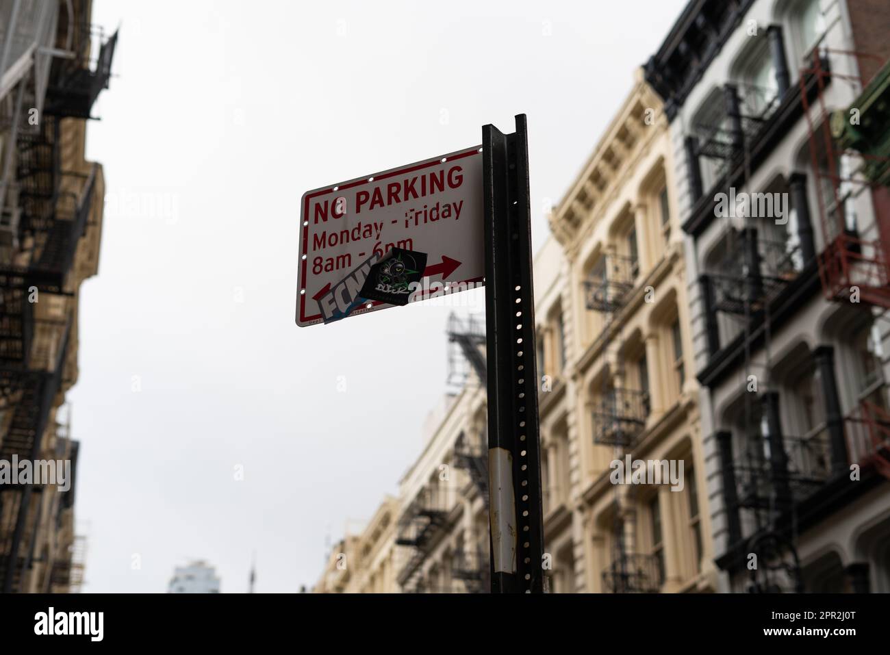 A vertical grey signpost is prominently featured in the center of the ...