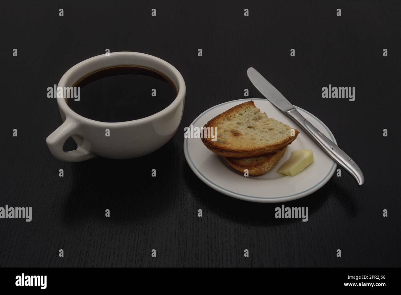 A classic white American diner-style coffee cup of black coffee sits ...
