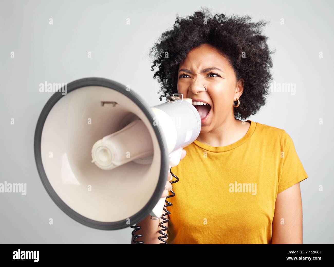 Megaphone, speech and angry woman in studio for message, broadcast or ...